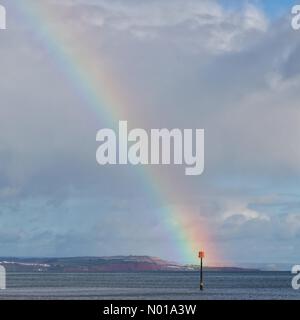 UK Weather: Rainbow at Teignmouth beach, Devon, UK. 5 Jan, 2024. Credit ...