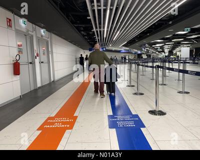 Passengers go through passport control booth at Chopin airport in ...