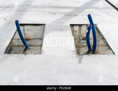 blue plastic tubes and piping for electrical wiring and concrete floor ...