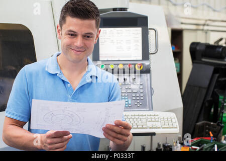 Male engineer working with technical drawing on computer indoors Stock ...