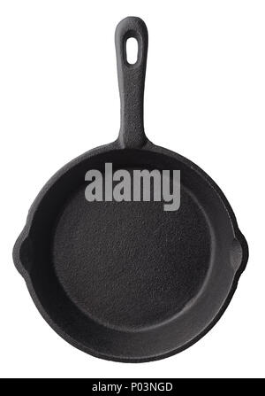 Black cast iron empty frying pan on a wooden cutting board and a gray ...