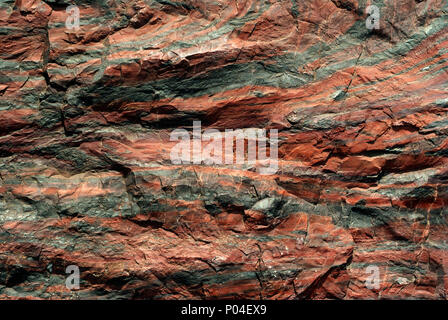 Background of a red rough cliff in the blue ocean Stock Photo - Alamy