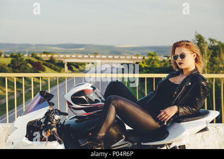 Woman Relaxing and Laying on a Motorcycle Stock Photo - Alamy