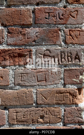 Red brick wall with multiple names embedded in the brick Stock Photo ...