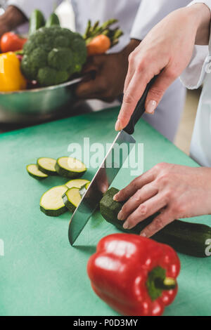 Cropped image of female chef cutting butter in kitchen Stock Photo - Alamy