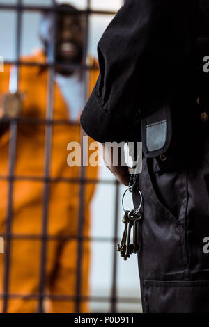 cropped image of security guard standing with gun isolated on grey ...