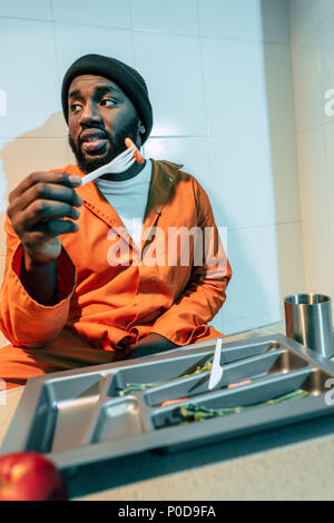 african american inmate eating in prison cell Stock Photo - Alamy