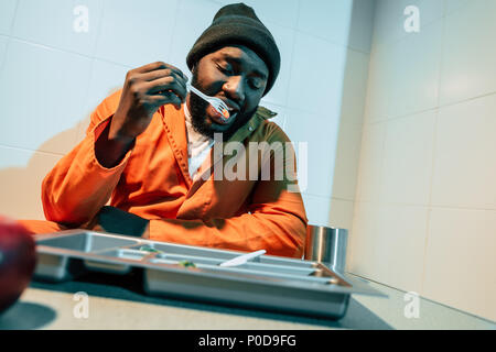 african american inmate eating in prison cell Stock Photo - Alamy