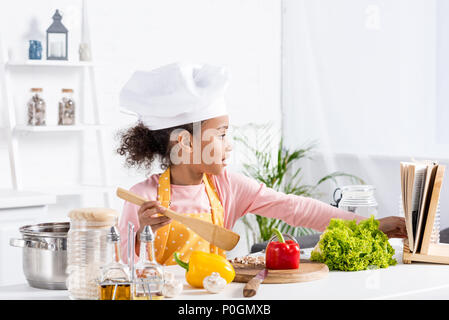 girl kid in chef apron and hat cooking, bakery Stock Photo - Alamy