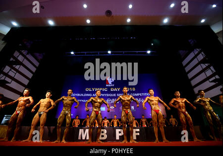 Contestants compete during their bodybuilding competition to mark ...