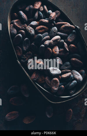Composition with cocoa beans on dark background Stock Photo - Alamy