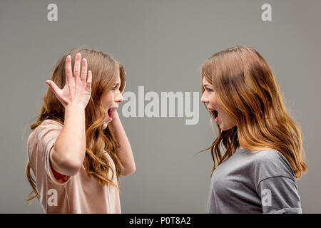 Twins screaming each other Stock Photo - Alamy