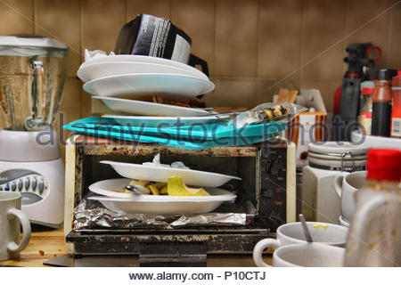 Messy Kitchen Counter With Dirty Plates, Cutlery, Glasses And Saucepans ...