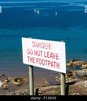 Cliff danger warning sign - with man falling over cliff, cliff edge ...