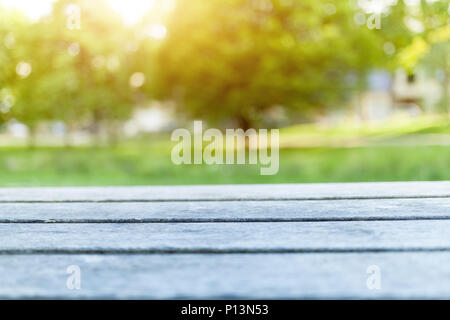 Empty wooden table with city park on background Stock Photo - Alamy