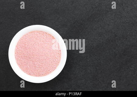 Red jelly or jello powder in small bowl on white wood (Selective Focus ...