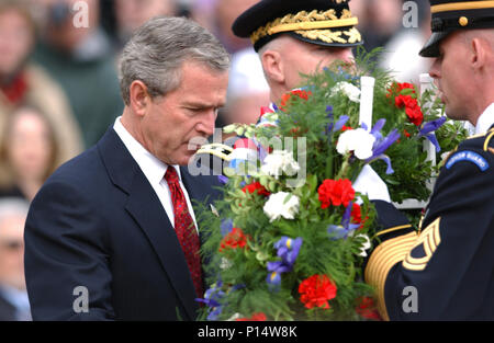 US President George W. Bush lays down on the jogging track to play with ...