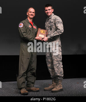 The commander of the 187th Fighter Wing presents the Outstanding Airman ...