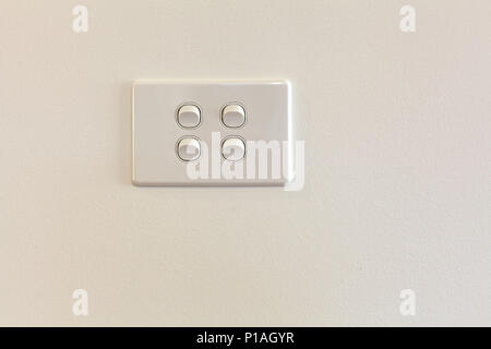Modern light switch on white wall Stock Photo - Alamy