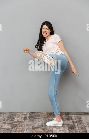 Image of emotional young lady fighting isolated over grey background ...