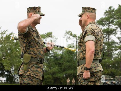 Col. Matthew Reid, left, and Sgt. Maj. Darrell Carver, center, unfurl ...