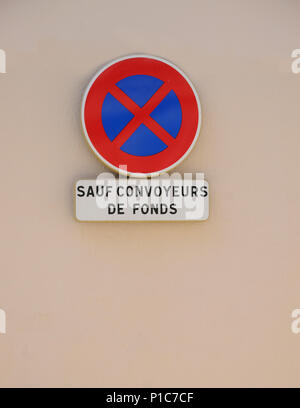 A red sign forbidding all vehicles except school buses to stop with a ...