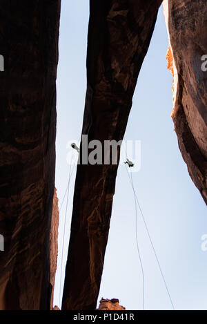 People rappelling from an arch in Moab, Utah Stock Photo - Alamy
