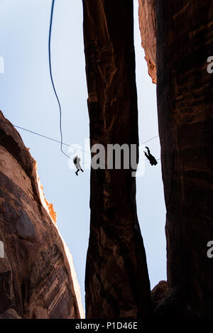 People rappelling from an arch in Moab, Utah Stock Photo - Alamy