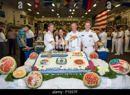 Cut a ceremonial cake at a Big Top reception on the flight deck aboard ...