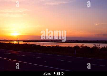 sunset on highway along wetlands Stock Photo - Alamy