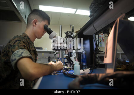 U.S. Marine Cpl. Riki D. Clement, a micro/miniature repair man with ...