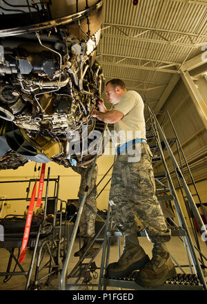 Airmen from the 5th Aircraft Maintenance Squadron use a MHU-83 Jammer to load an inert munition ...