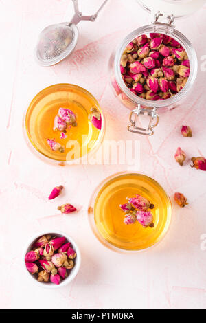 Herbal tea with dryed roses n glass jar and two glasses Stock Photo - Alamy