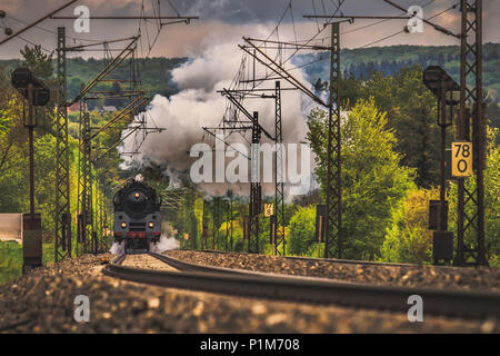 Steam locomotive at full throttle in the countryside Stock Photo - Alamy