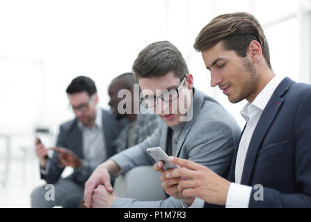 business colleagues reading SMS on smartphone Stock Photo - Alamy