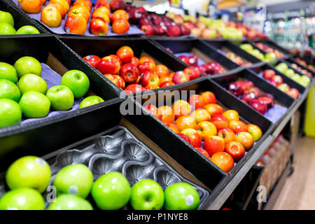 Many varieties assorted apples on display shelf in grocery store boxes ...