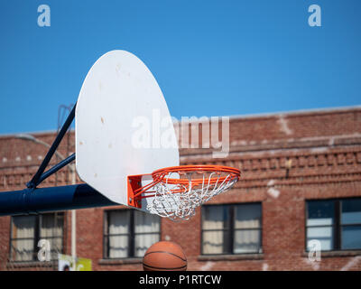 Street basketball ball falling into the hoop at night. Urban youth game ...