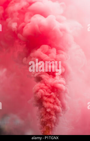 Thick colorful smoke of red, pink and blue on a black isolated ...