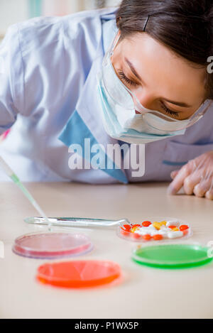 Lab assistant in drug synthesis concept Stock Photo - Alamy