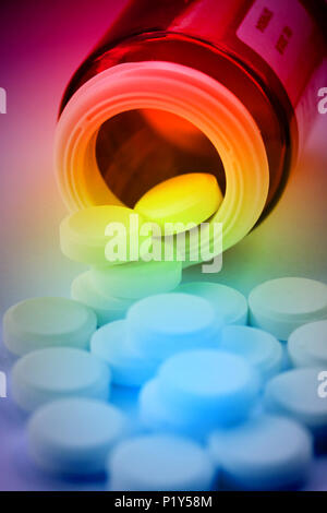 Pile of pills coming out fro a pill bottle in color fantasy with ...