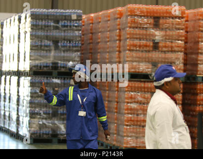 Harare, Zimbabwe. 13th June, 2018. Staff members work near a production ...