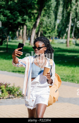 Woman taking a selfie with coffee paper cup at her workplace Stock ...