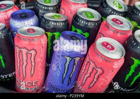Advertising for Monster brand energy drinks are seen on a lamp post ...