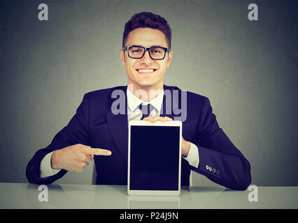 Young hispanic man at the office showing and pointing up with fingers ...