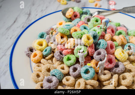 Tiny painting crew paints the oat loop cereal rainbow of colors Stock ...
