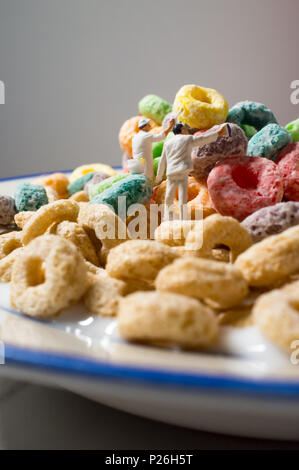 Tiny painting crew paints the oat loop cereal rainbow of colors Stock ...