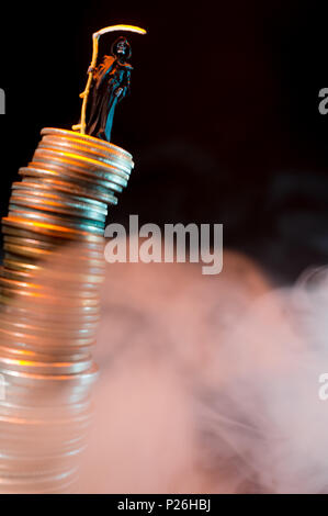 Grim reaper with pile of cash symbolizing the evil of money Stock Photo ...