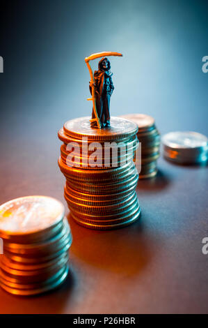 Grim reaper with pile of cash symbolizing the evil of money Stock Photo ...