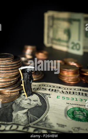 Grim reaper with pile of cash symbolizing the evil of money Stock Photo ...