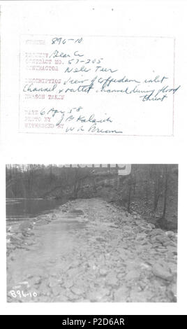 Water flows over a dam structure and crashes to the bottom of the ...